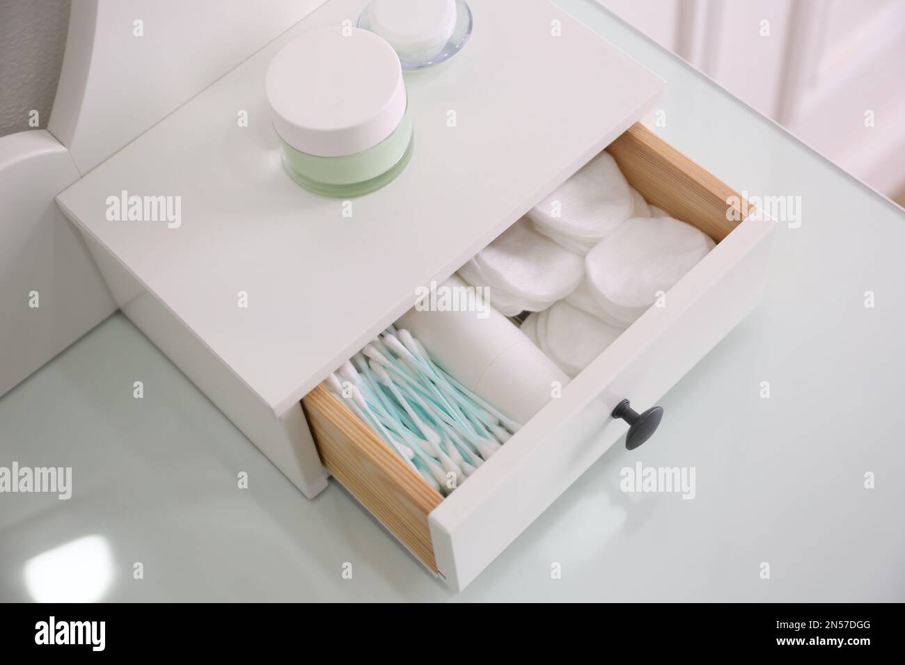 Drawer with cotton buds and pads in dressing table Stock Photo - Alamy