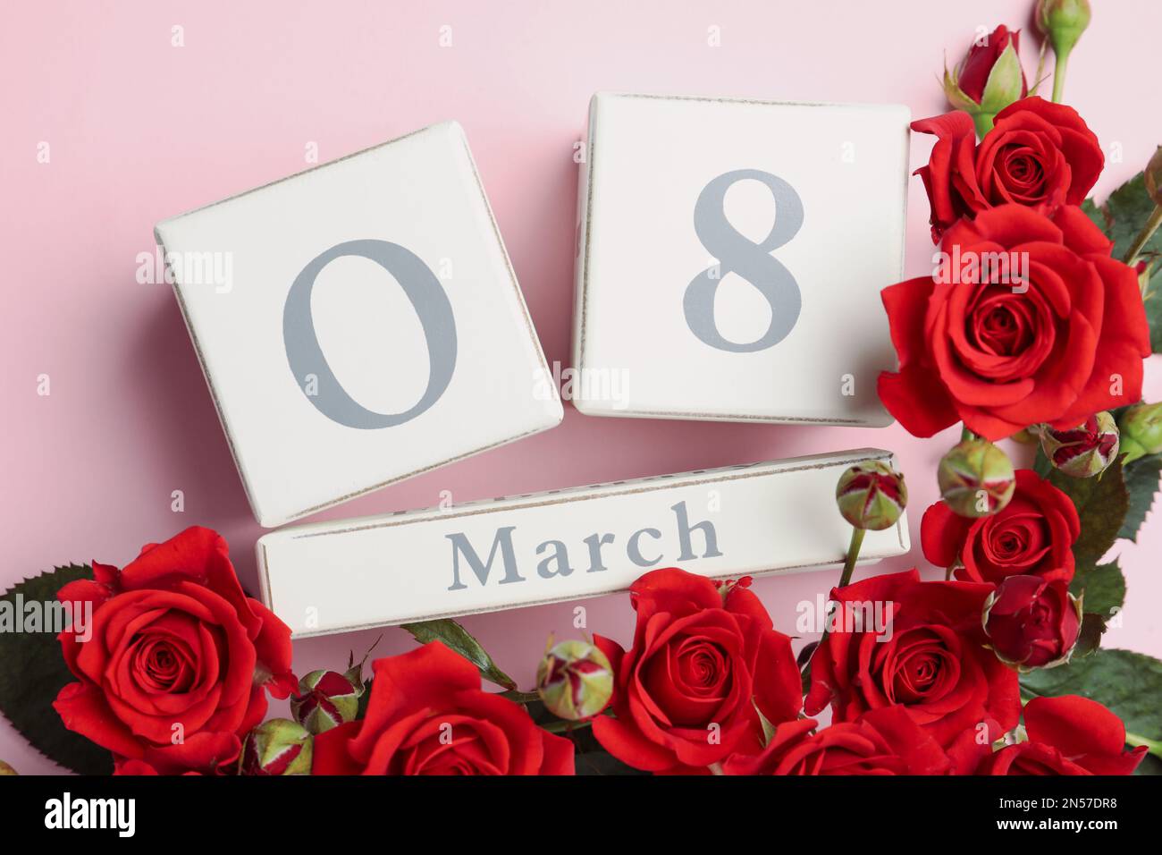 Wooden block calendar with date 8th of March and roses on pink ...