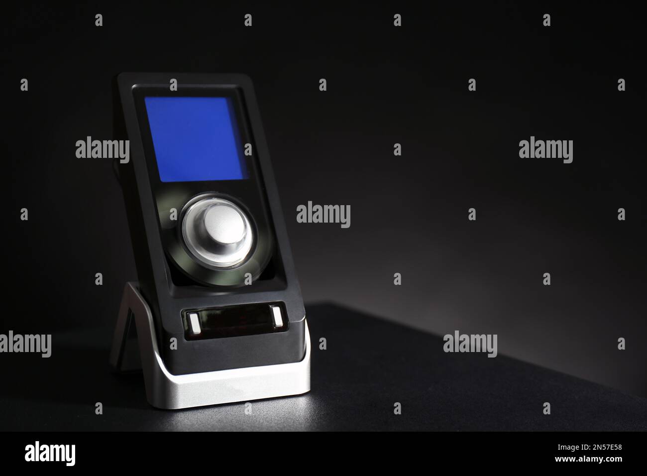 Remote control of audio speaker system on black table. Space for text ...