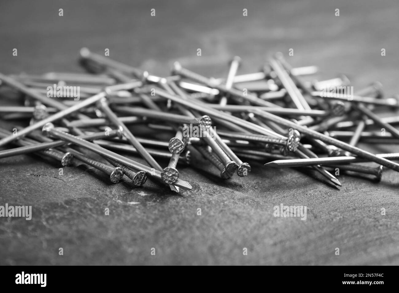 Pile of metal nails on grey background Stock Photo - Alamy