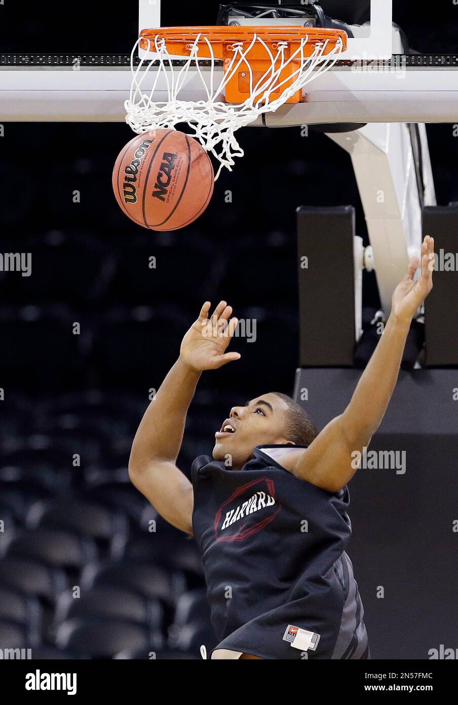 Harvard's Wesley Saunders dunks during practice for the NCAA college ...