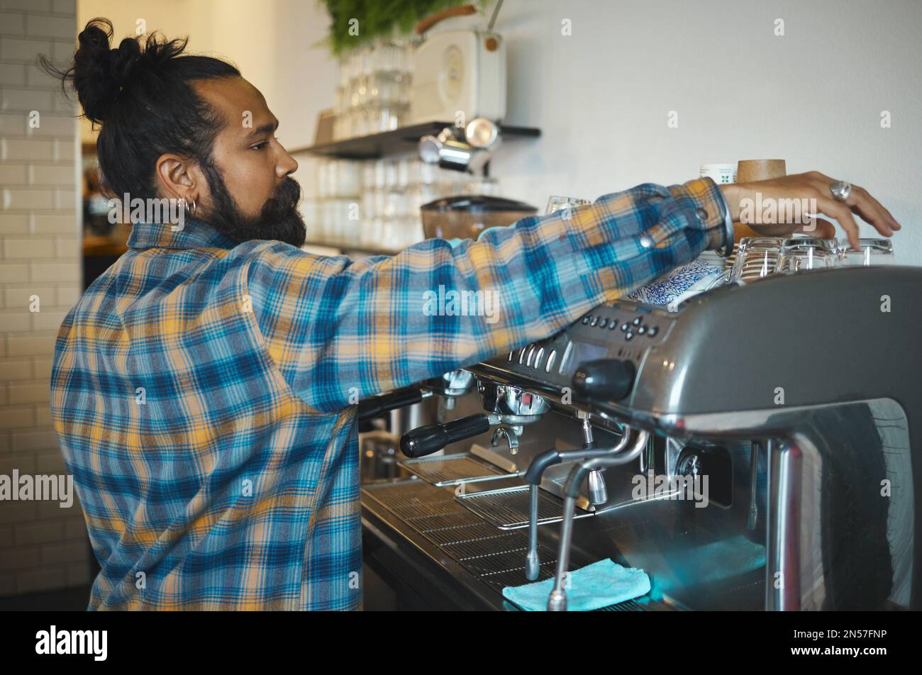 Man in cafe, barista and machine for drink with focus and small ...