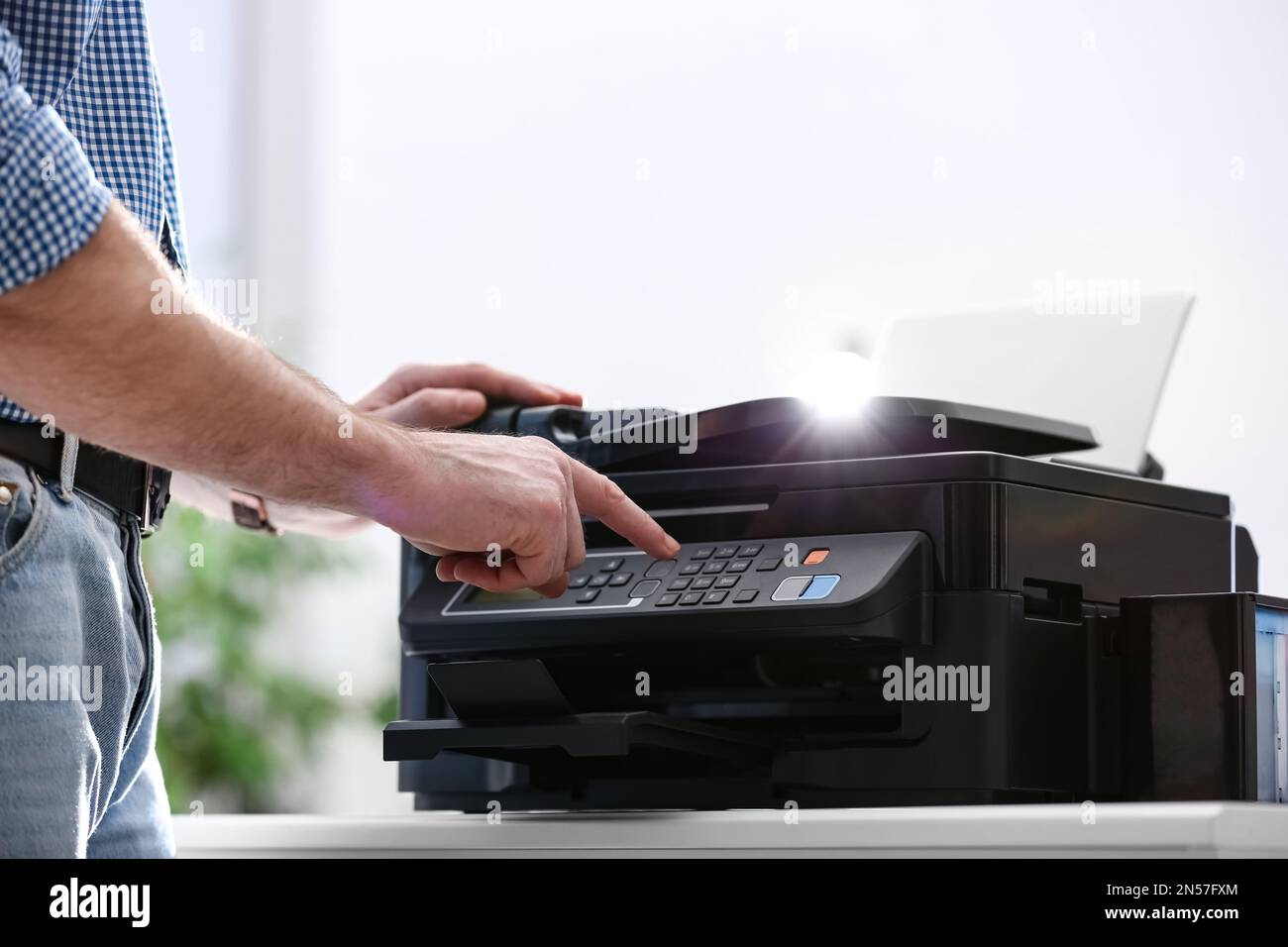 Employee using modern printer in office, closeup Stock Photo - Alamy