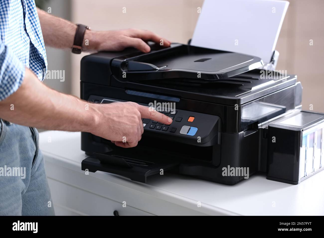 Employee using modern printer in office, closeup Stock Photo - Alamy