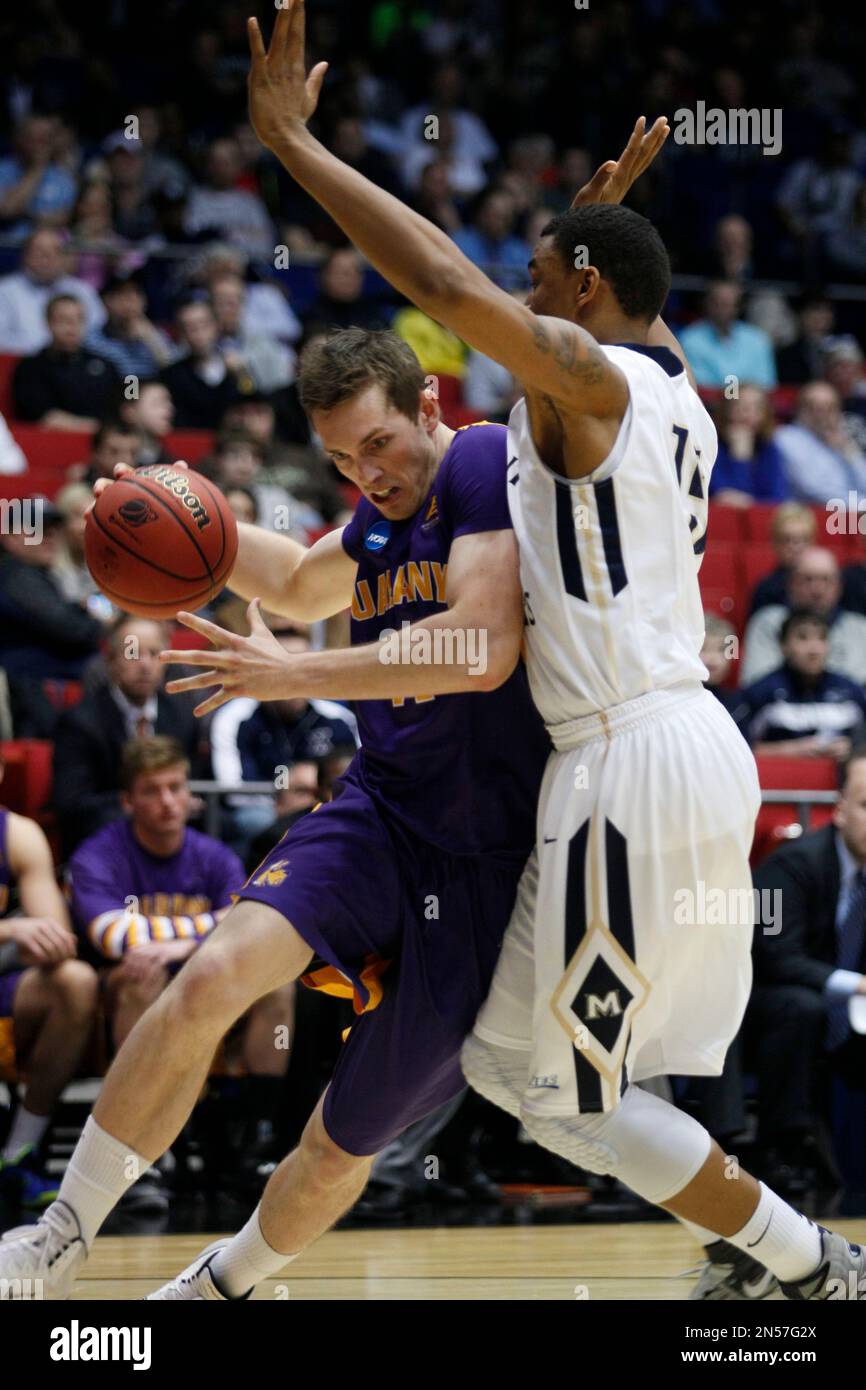 Albany forward Luke Devlin, left, drives against Mount St. Mary's ...
