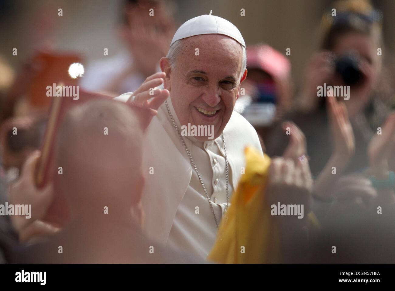 Pope Francis blesses the crowd as he arrives in St. Peter's Square at ...