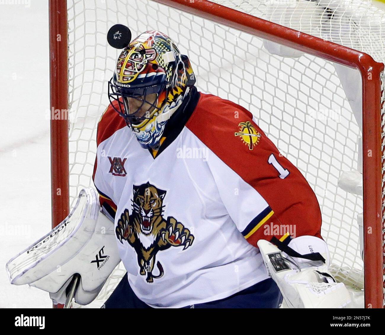 Florida Panthers goalie Roberto Luongo stops a shot with his helmet ...