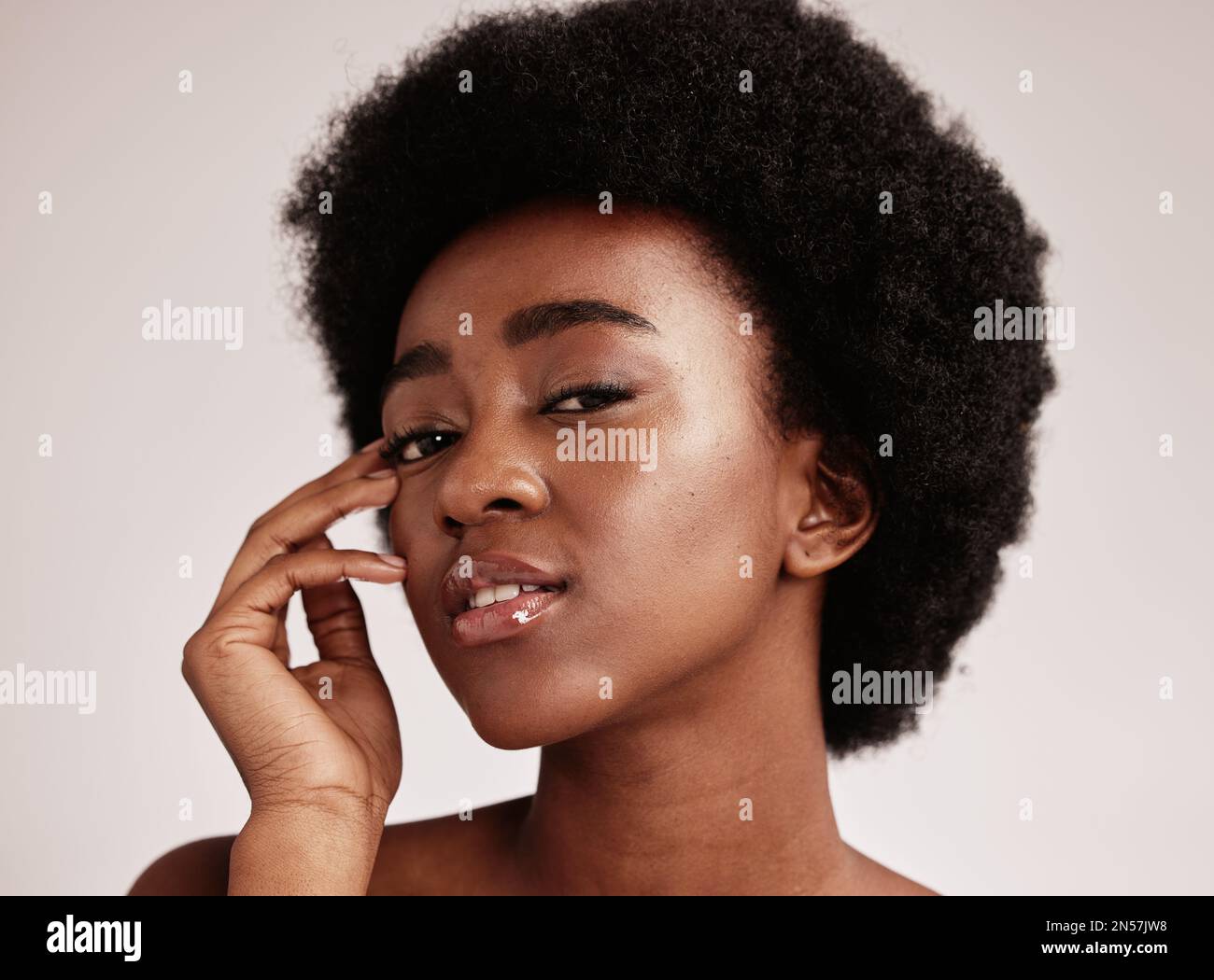 Portrait, beauty or natural and a model black woman in studio on a gray ...