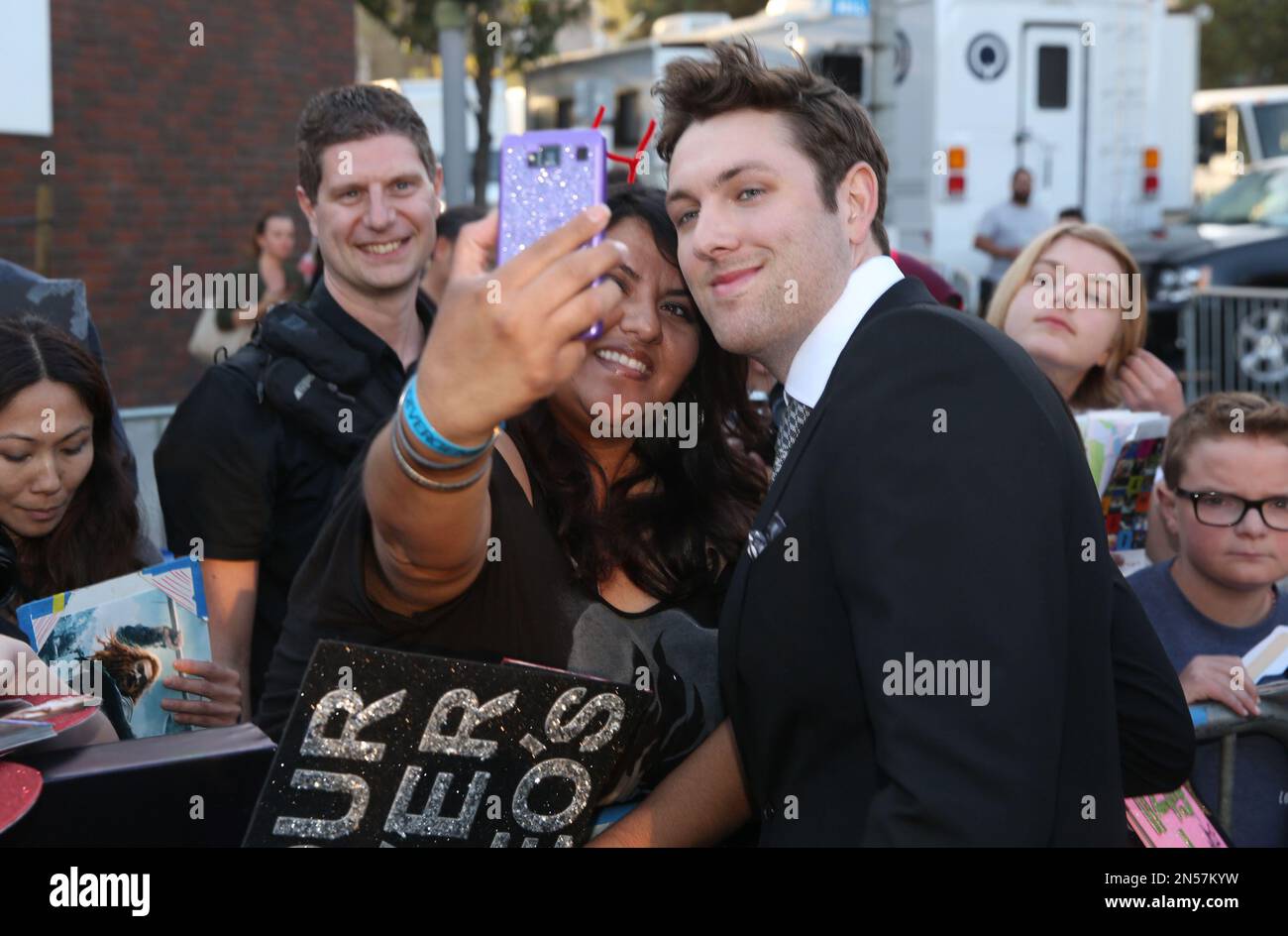 Christian Madsen poses with fans at the world premiere of "Divergent ...