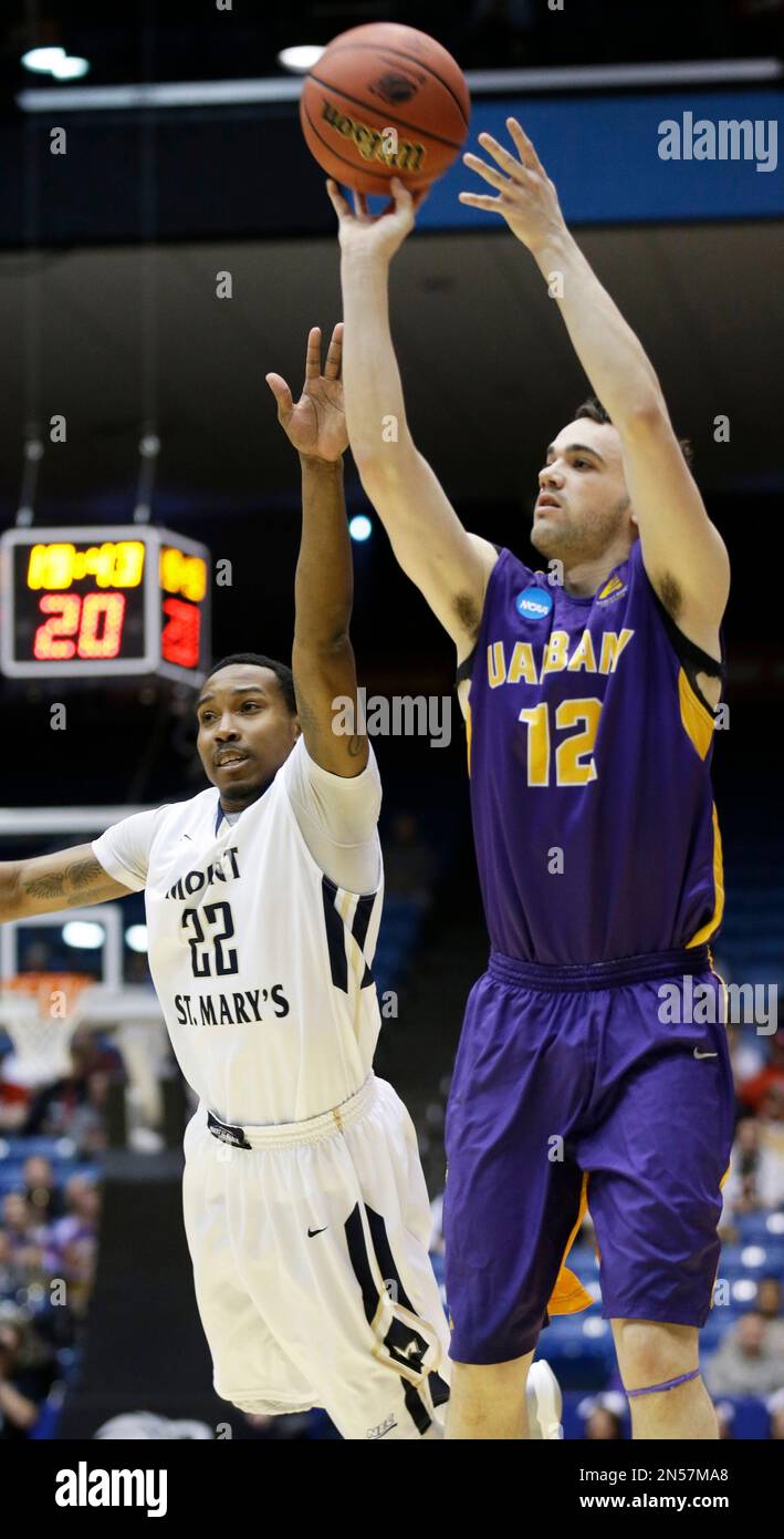 Albany guard Peter Hooley (12) shoots against Mount St. Mary's guard ...