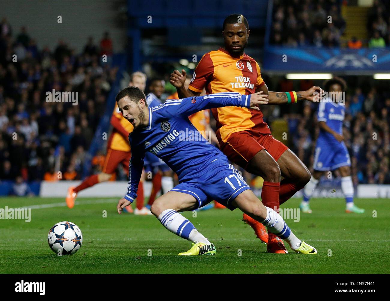 Chelsea's Eden Hazard, left, grimaces after being tripped by ...