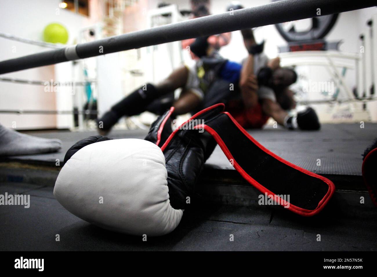 Two athletes, background, out of focus, fight in the ring during a ...