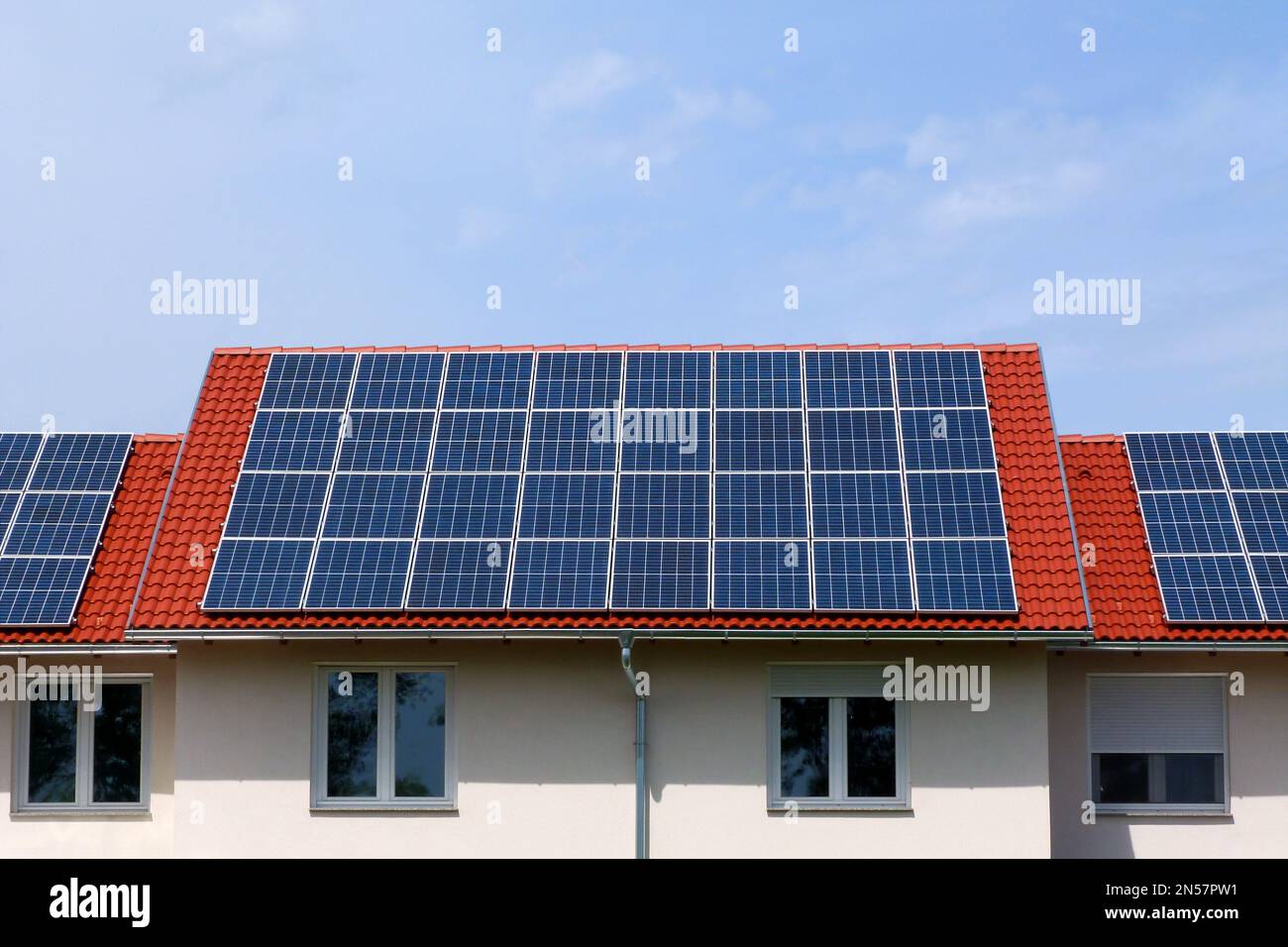 photovoltaic PV sun collector solar panels on sloped clay house roof ...