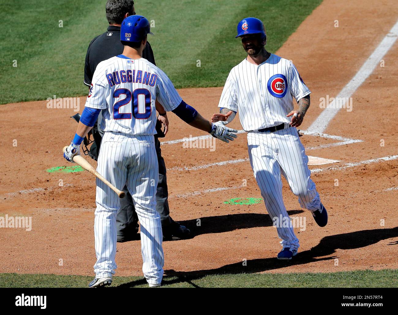 Chicago Cubs' Ryan Roberts, right, is greeted by Justin Ruggiano (20 ...
