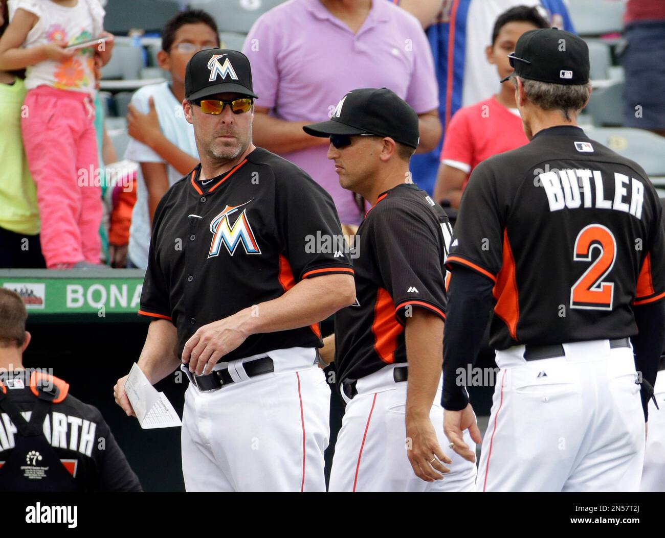 Miami Marlins manager Mike Redmond, left, looks out toward the field ...