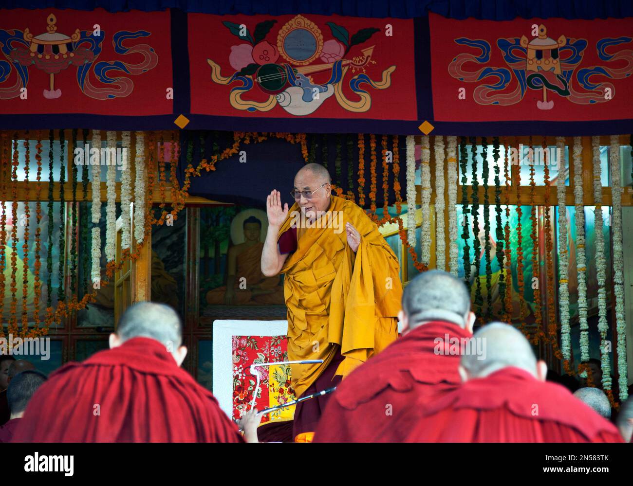 Tibetan spiritual leader the Dalai Lama greets devotees as he arrives ...