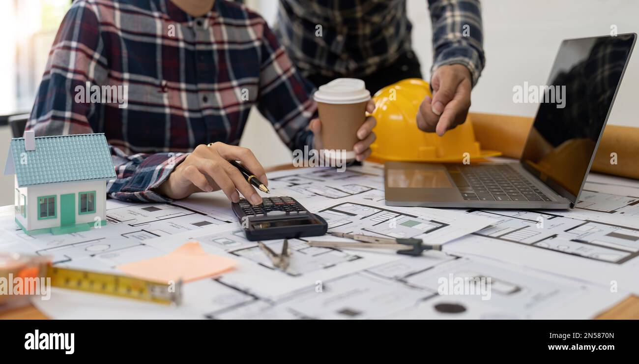 Close Up Architect Or Engineer Using On Calculator For Calculating Value Estimating For Safety