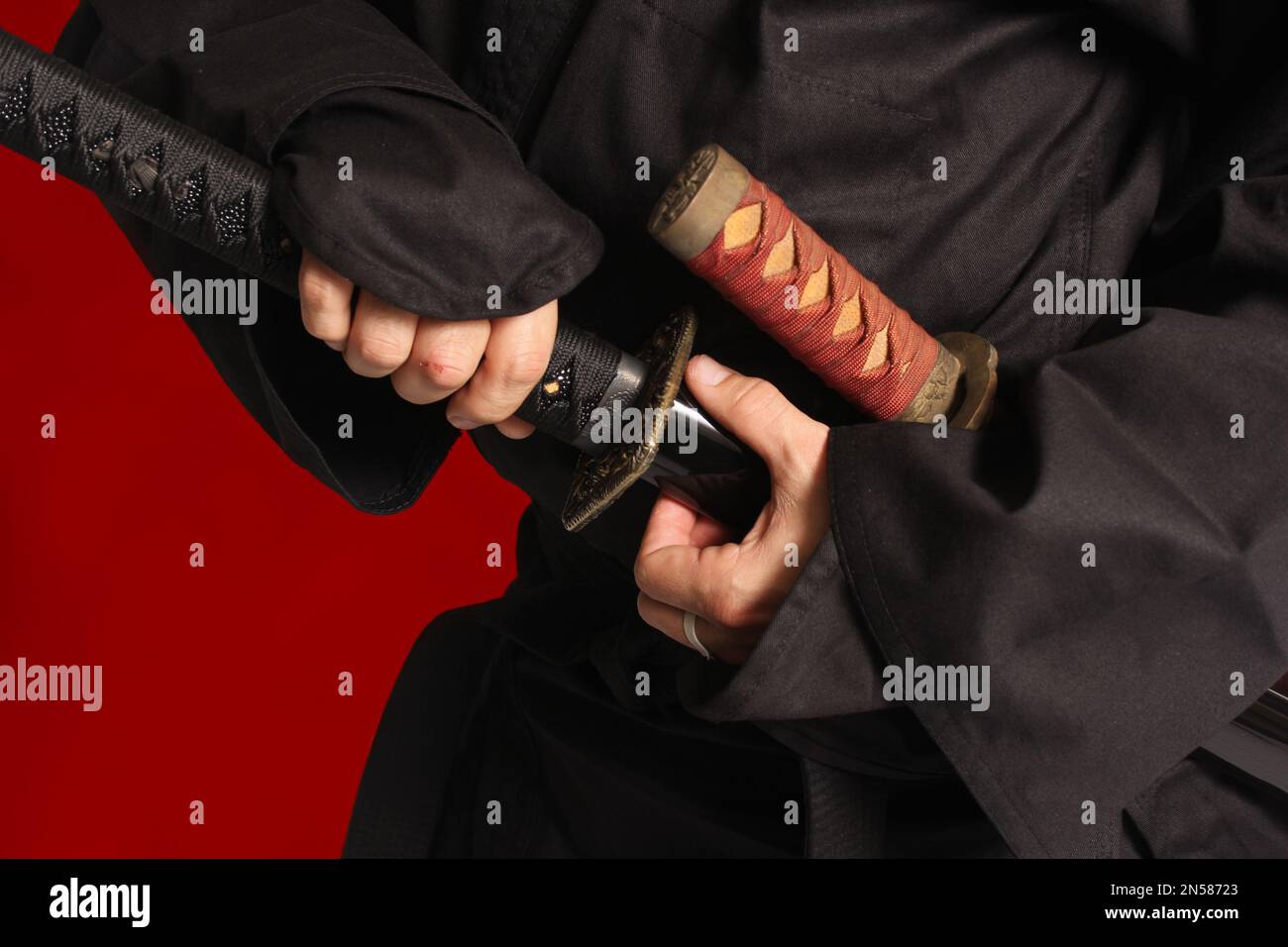 Man Removing Japanese Katana Sword From Scabbard Stock Photo - Alamy