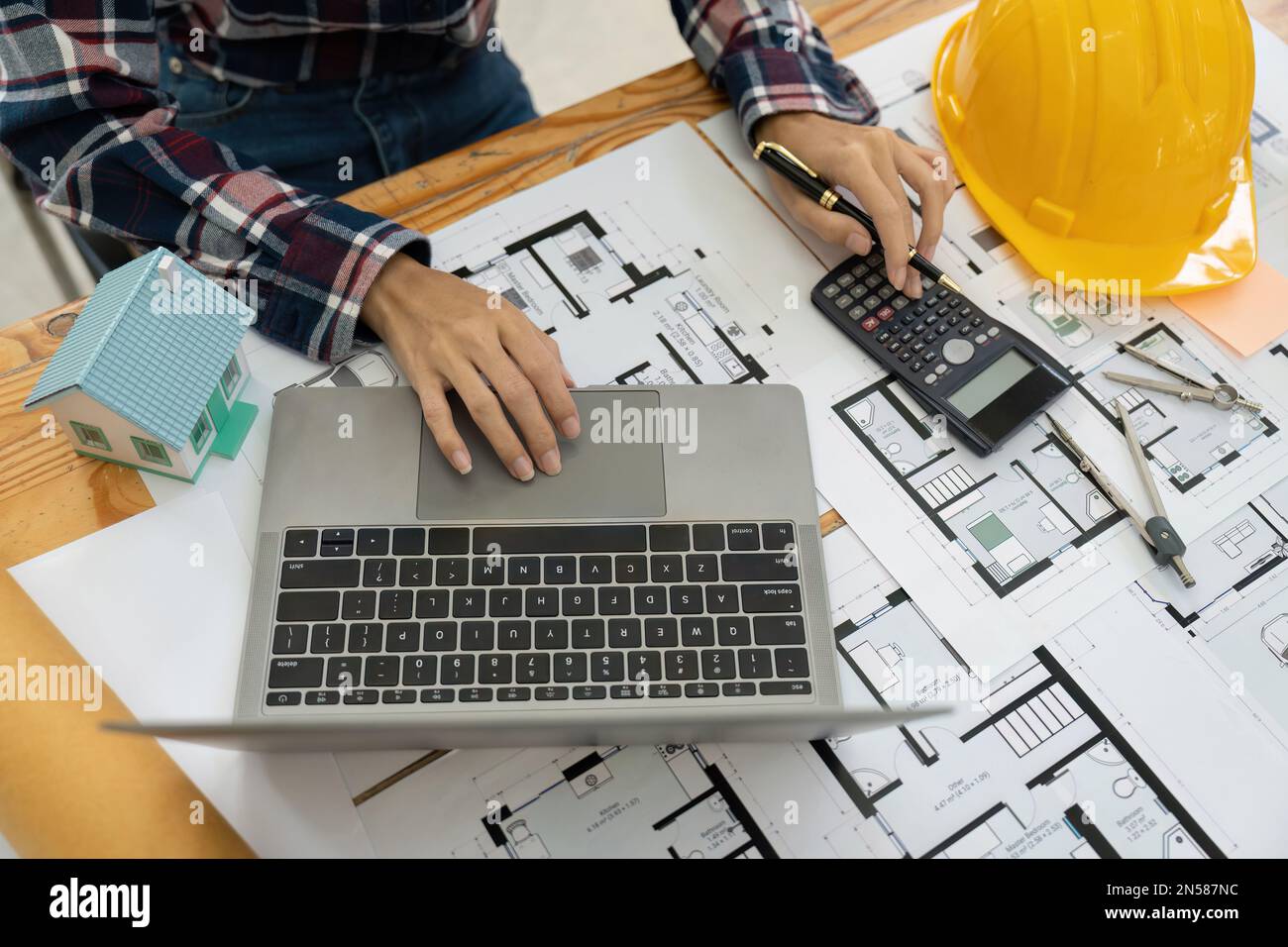 Close up Architect or Engineer using on calculator for calculating ...