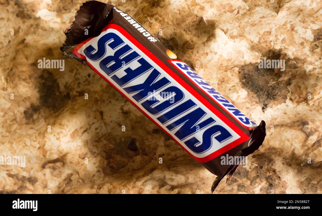Сhocolate bar Snickers on a brown background Stock Photo - Alamy