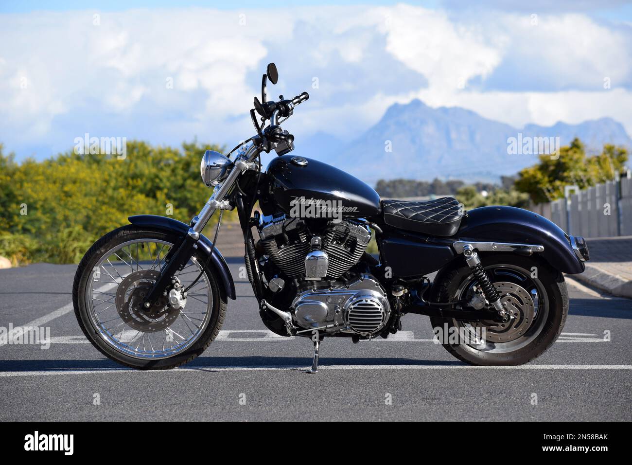 Harley-Davidson motorcycle in scenic mountain background. For websites ...