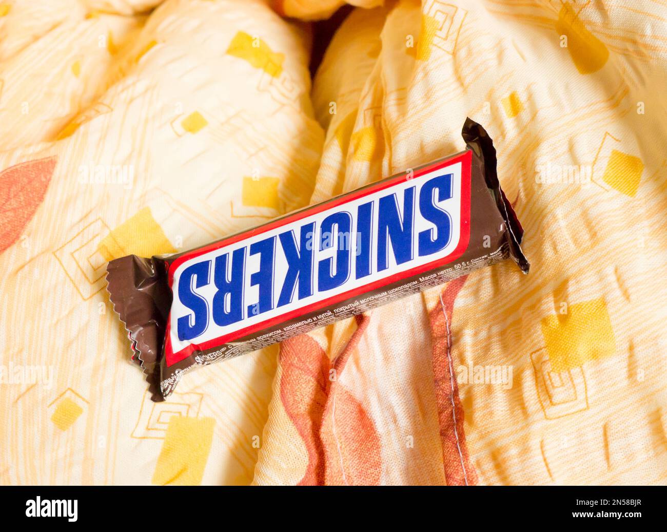 Сhocolate bar Snickers on a brown background Stock Photo - Alamy