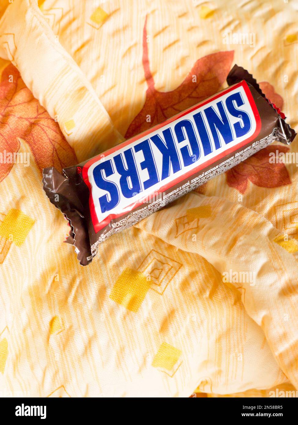Сhocolate bar Snickers on a brown background Stock Photo - Alamy
