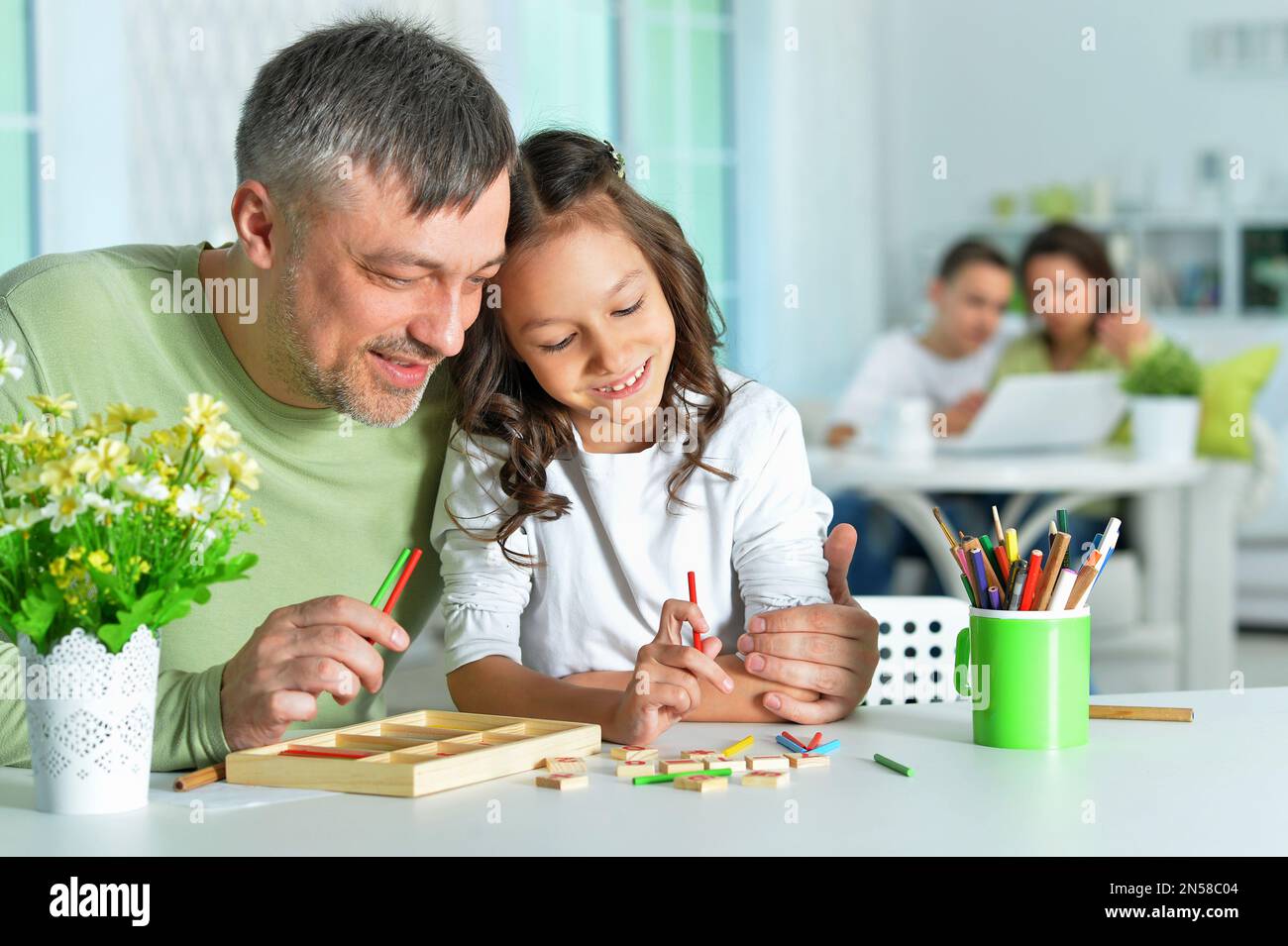 Father helps his cute little daughter Stock Photo - Alamy