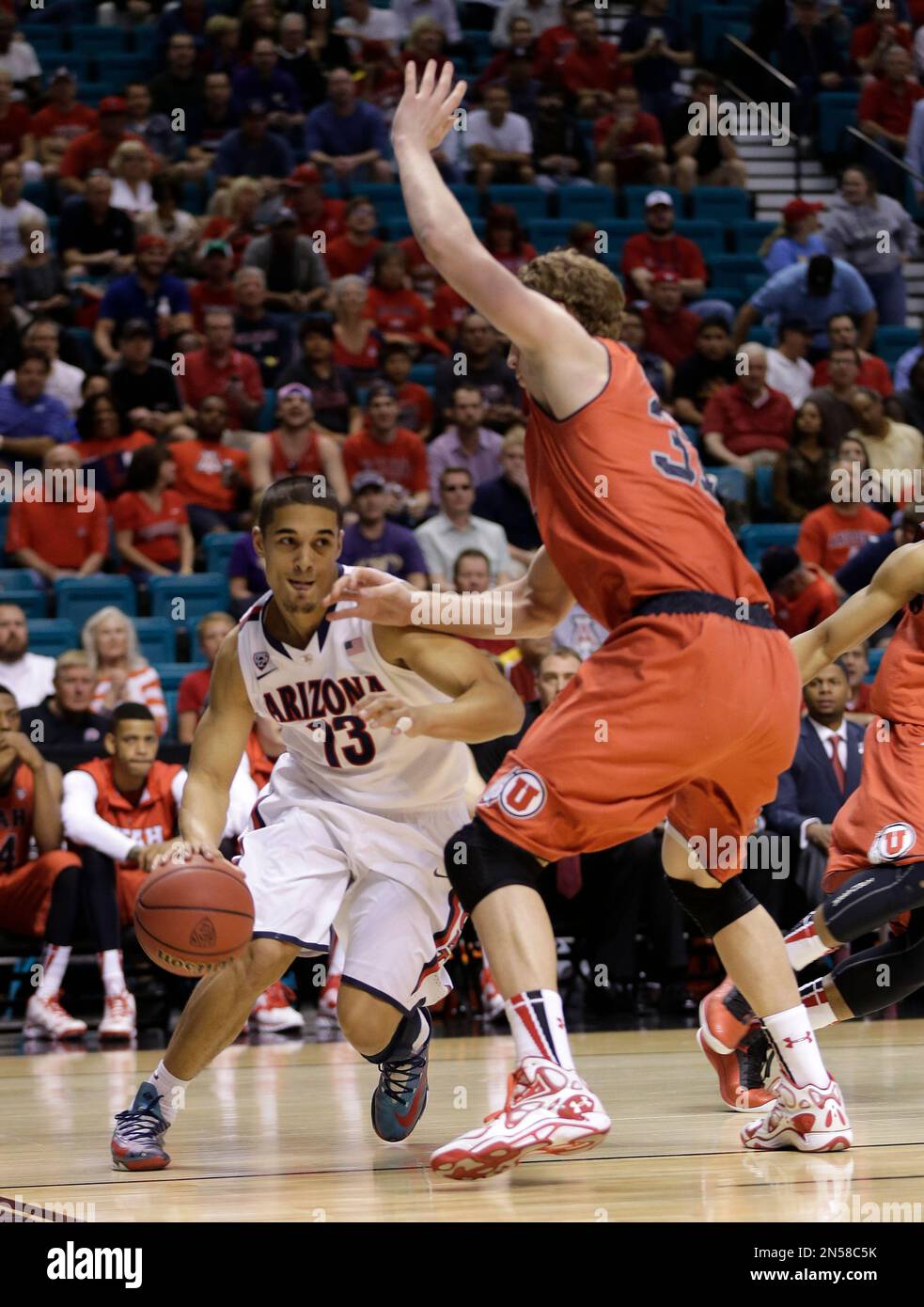 Arizona's Nick Johnson drives against Utah's Dallin Bachynski in the ...