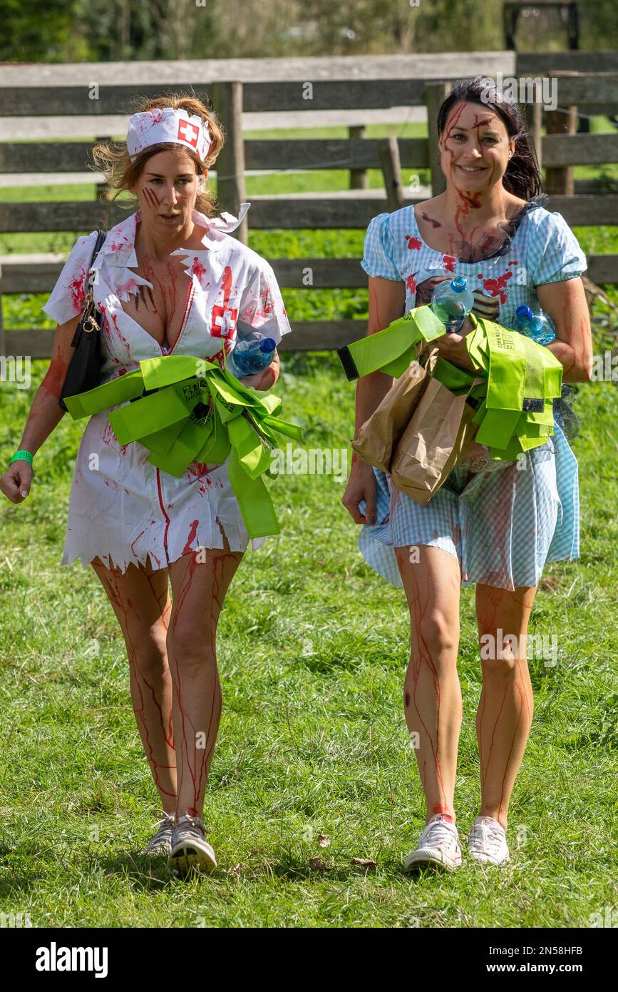 A zombie nurse and girl next door walk back carrying the streamers they ...