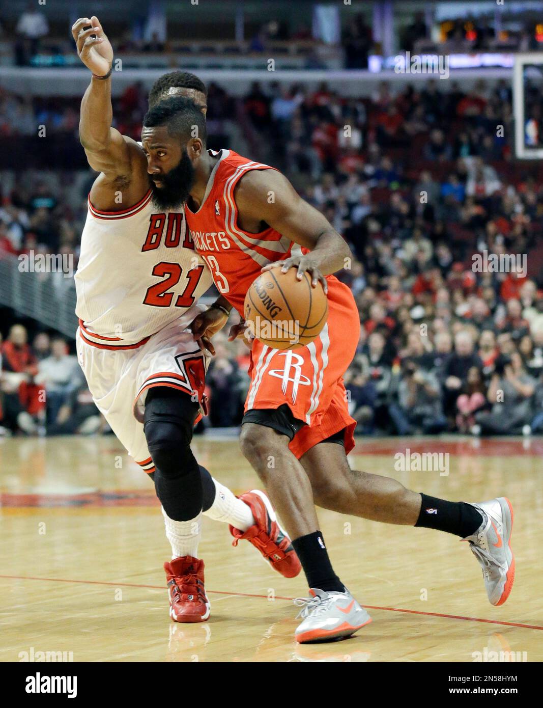 Houston Rockets guard James Harden, right, drives to the basket as ...