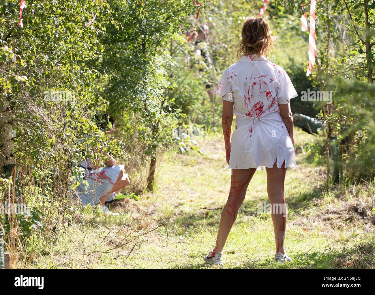 At a Zombie Evacuation event in Norfolk a blood splattered nurse on a ...