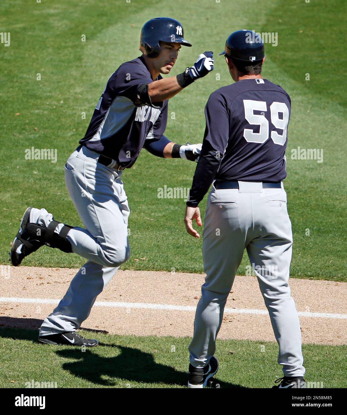 New York Yankees third base coach Rob Thomson (59) congratulates the ...
