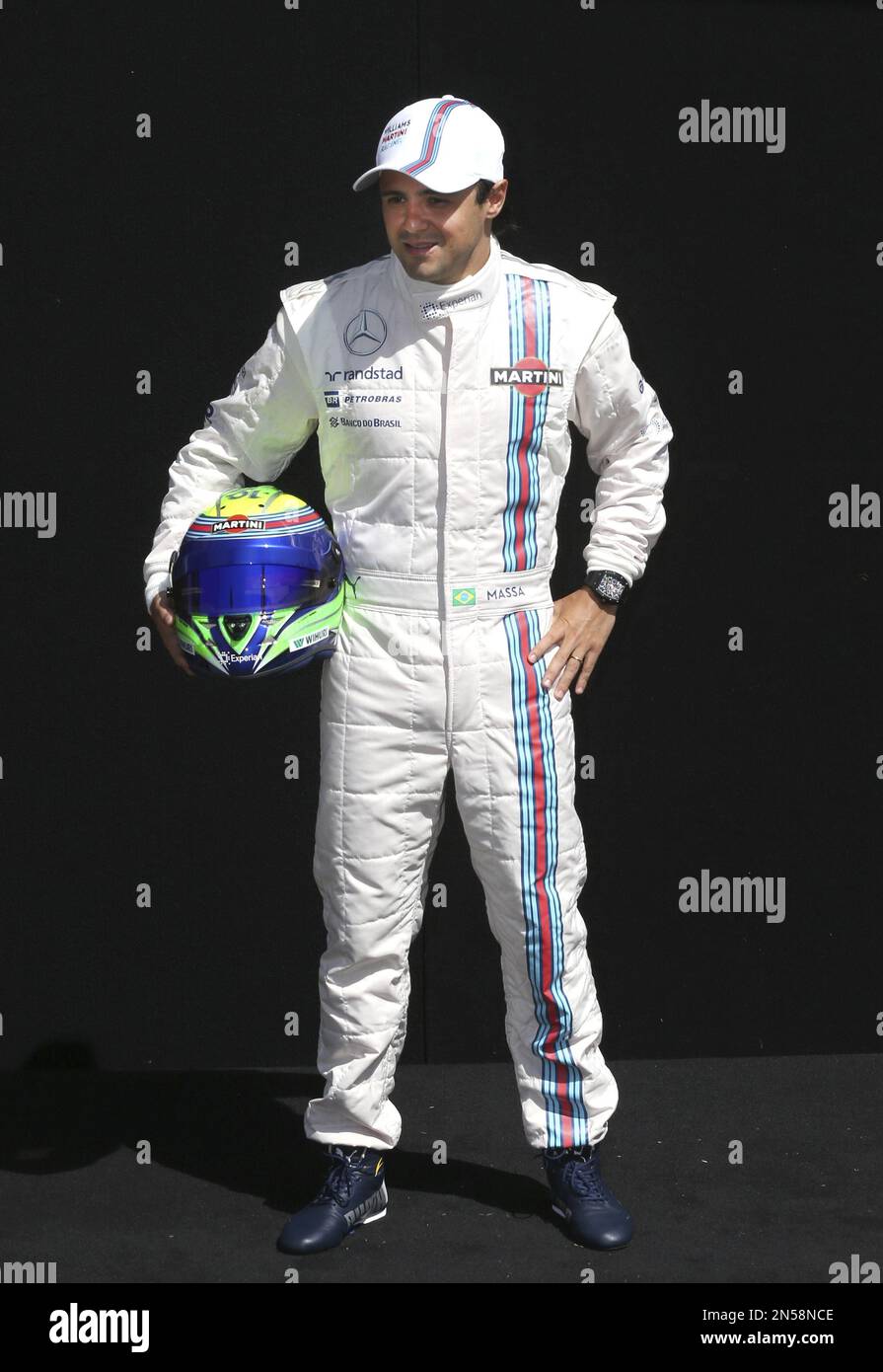 Williams driver Felipe Massa of Brazil holds his helmet as he poses for ...