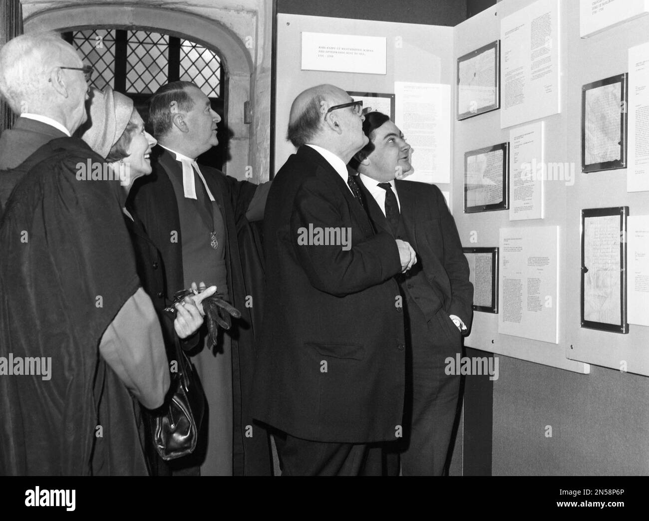 English historian Sir Arthur Bryant, right with glasses, looks at ...