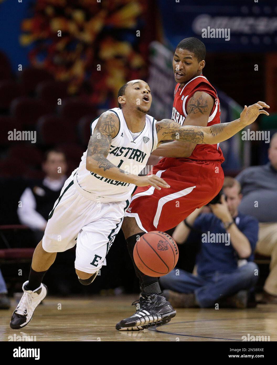 Eastern Michigan's Mike Talley, left, is fouled by Northern Illinois ...