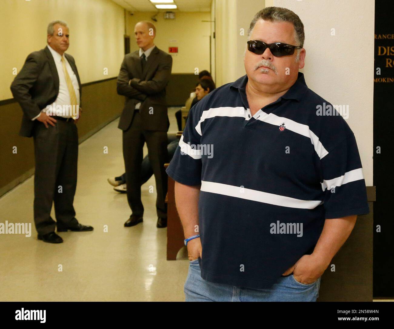 Gene Jones, the father of Michael Jones, waits to enter the courtroom ...
