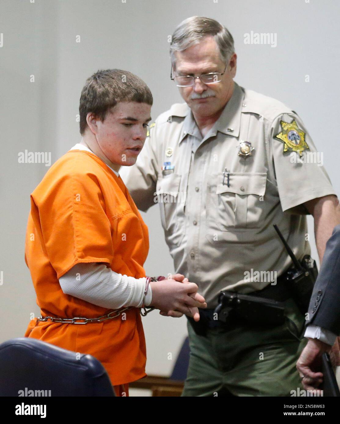 In this photo shot through a courtroom door, defendant Michael Jones is ...