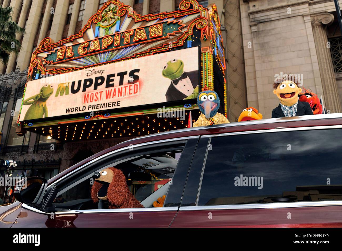 "Muppets Most Wanted" cast members peer out at the crowd as they arrive ...