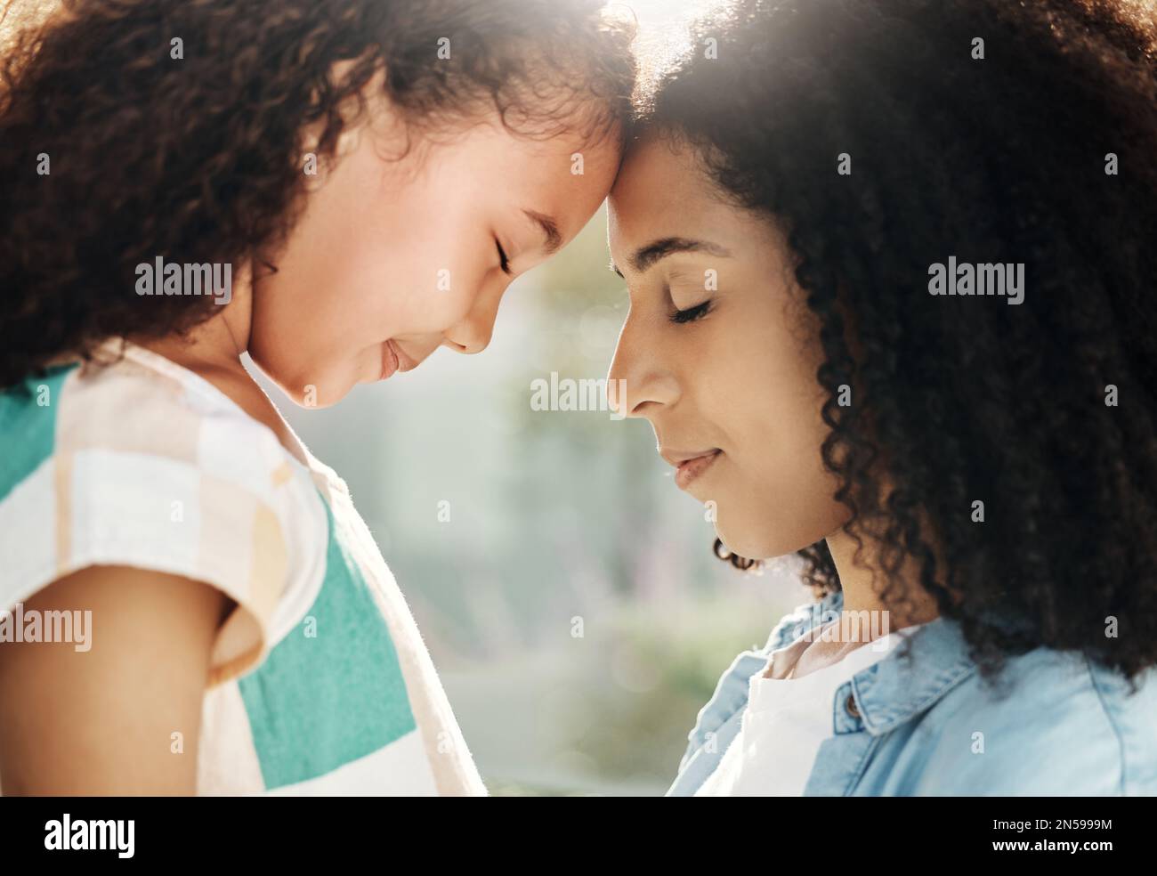 Family, mother and child with love and peace outdoor, forehead touching ...