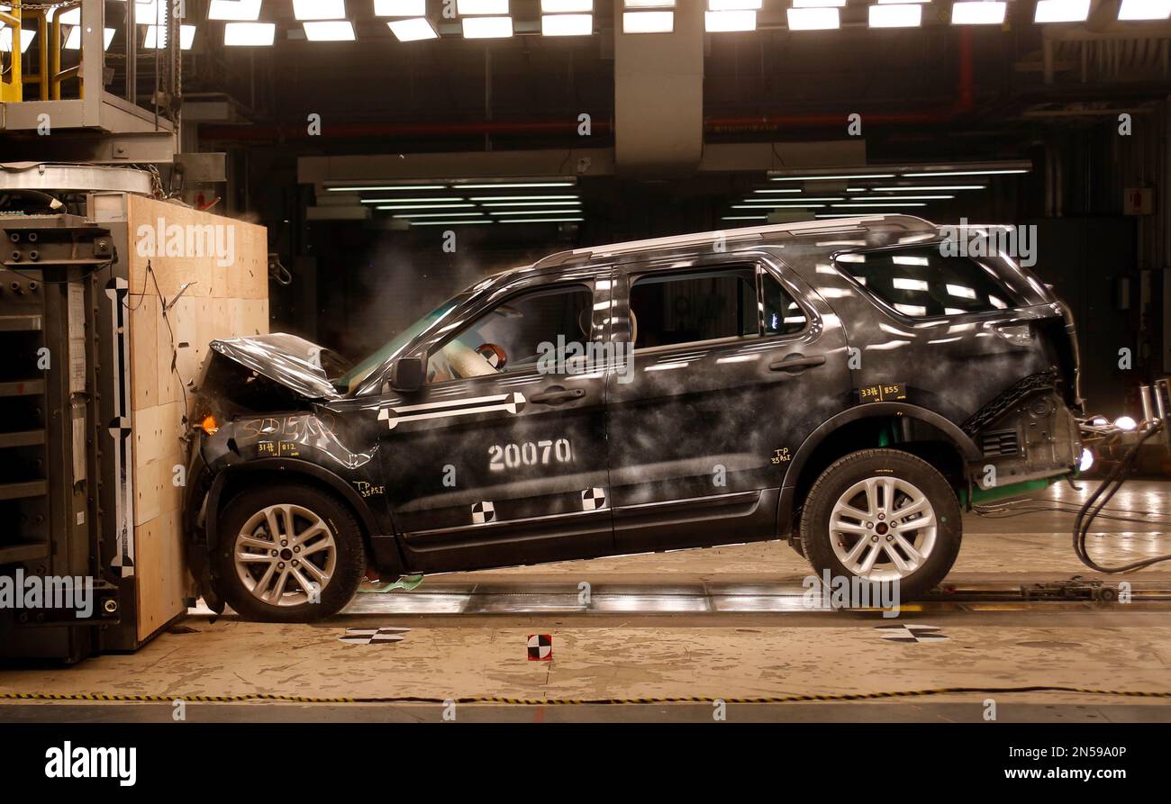 A 2014 Ford Explorer collides with a barrier during a crash test ...