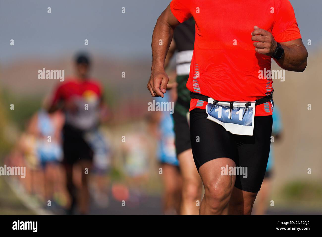 Marathon man running on the asphalt road Stock Photo - Alamy