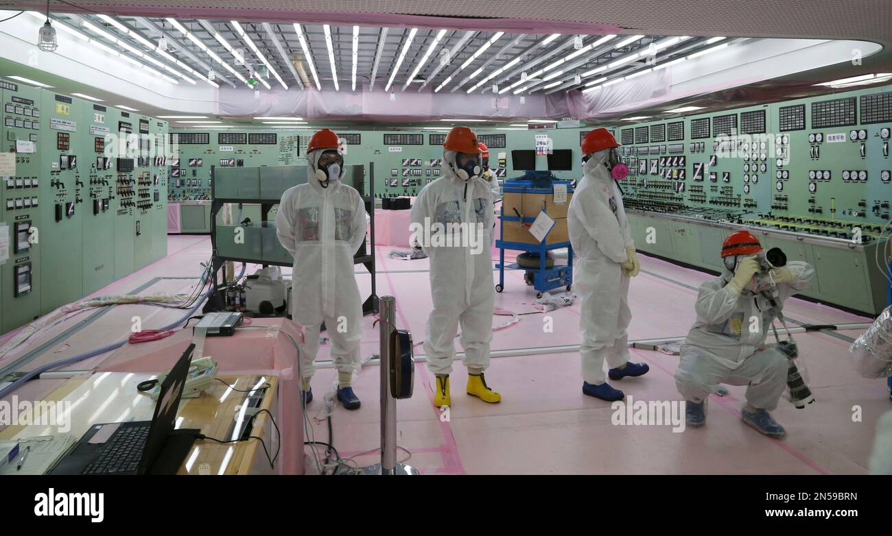 A still photographer takes pictures inside the central control room of ...