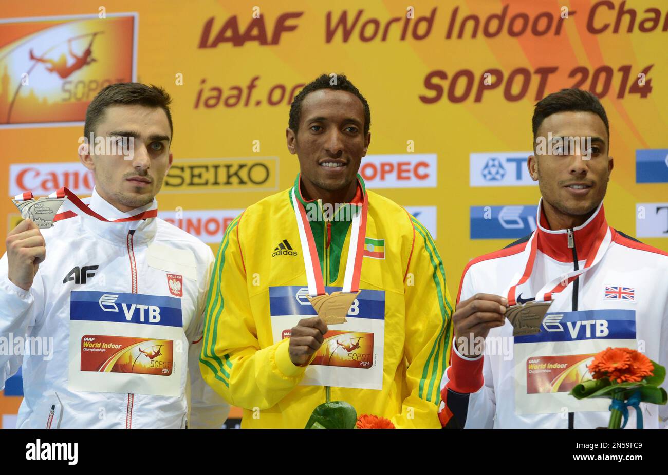 Ethiopia's gold medal winner Mohammed Aman is flanked by Poland's ...
