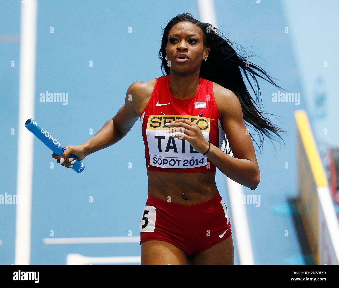 United States' Cassandra Tate crosses the finish line to help her team ...
