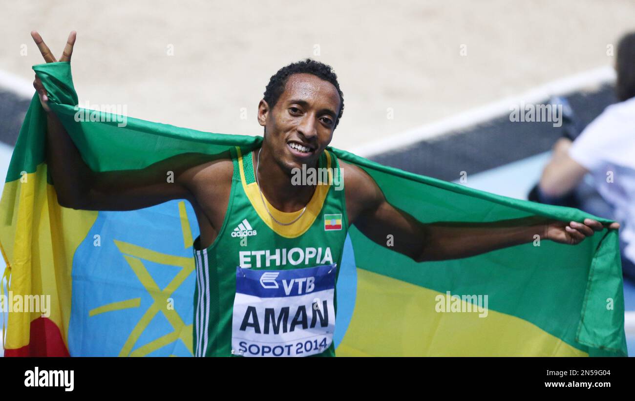 Ethiopia's Mohammed Aman carries the national flag after winning the ...