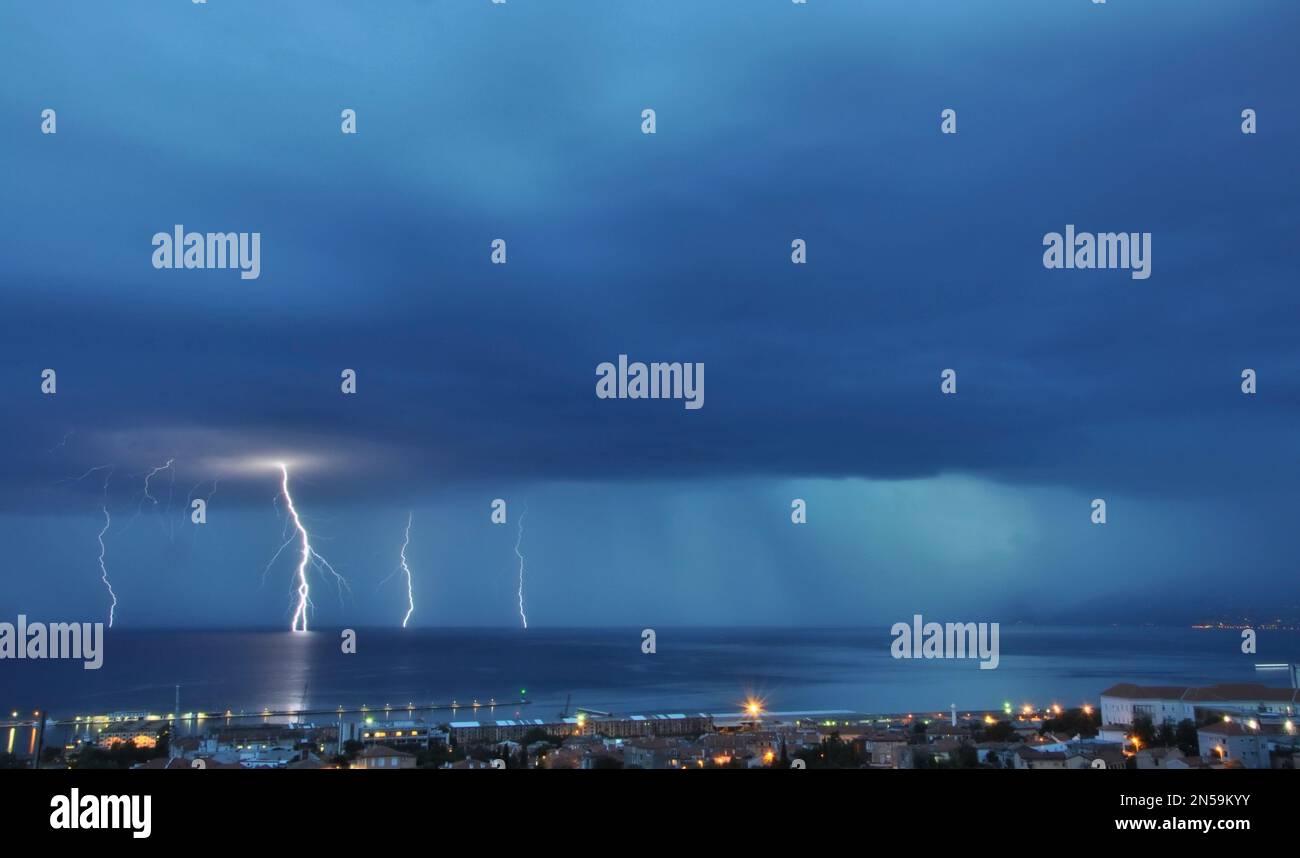 Rijeka city during thunder storm. Thunder bolts strikes sea near Rijeka ...