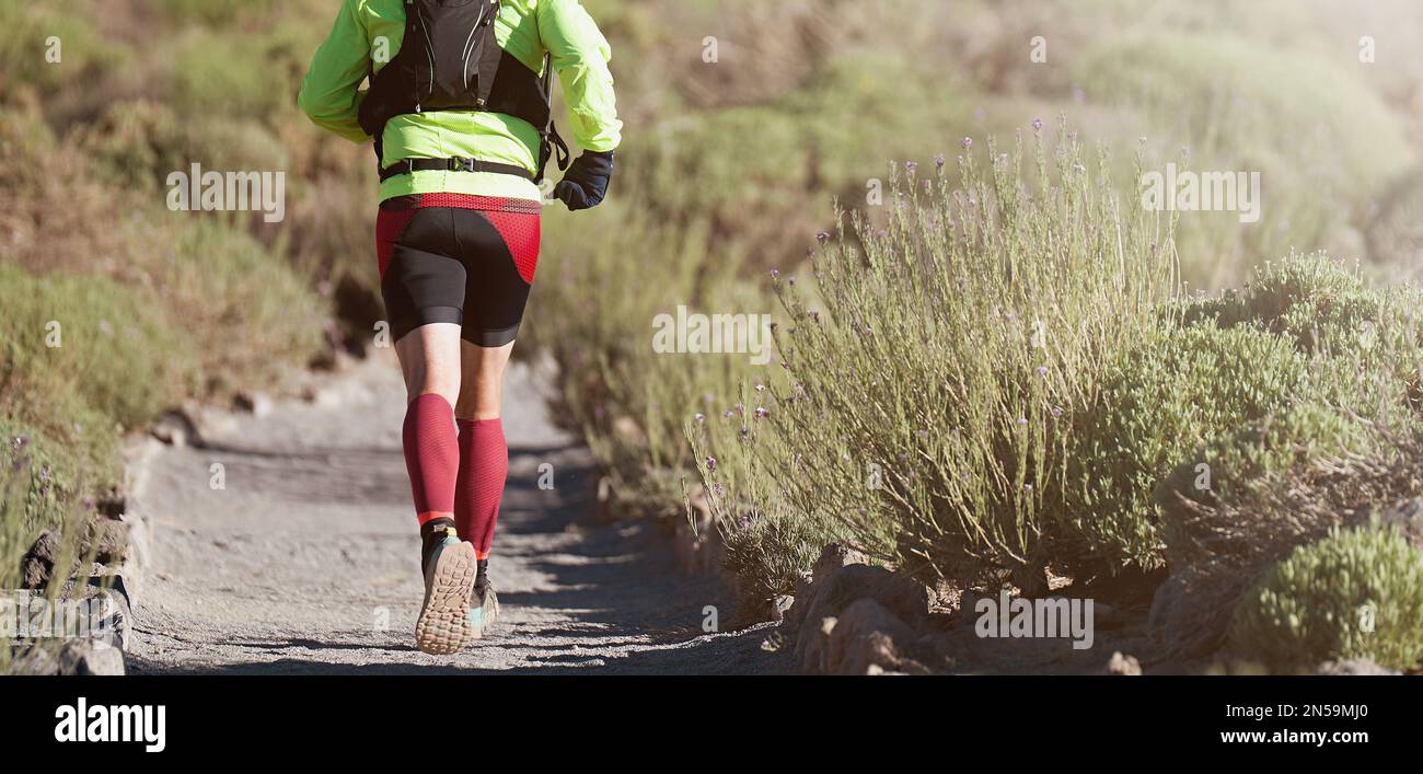 Trail running athlete exercising for fitness and health outdoors on ...