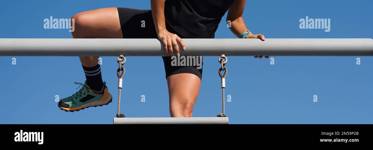 The racer overcomes the obstacle by climbing the ladder Stock Photo - Alamy
