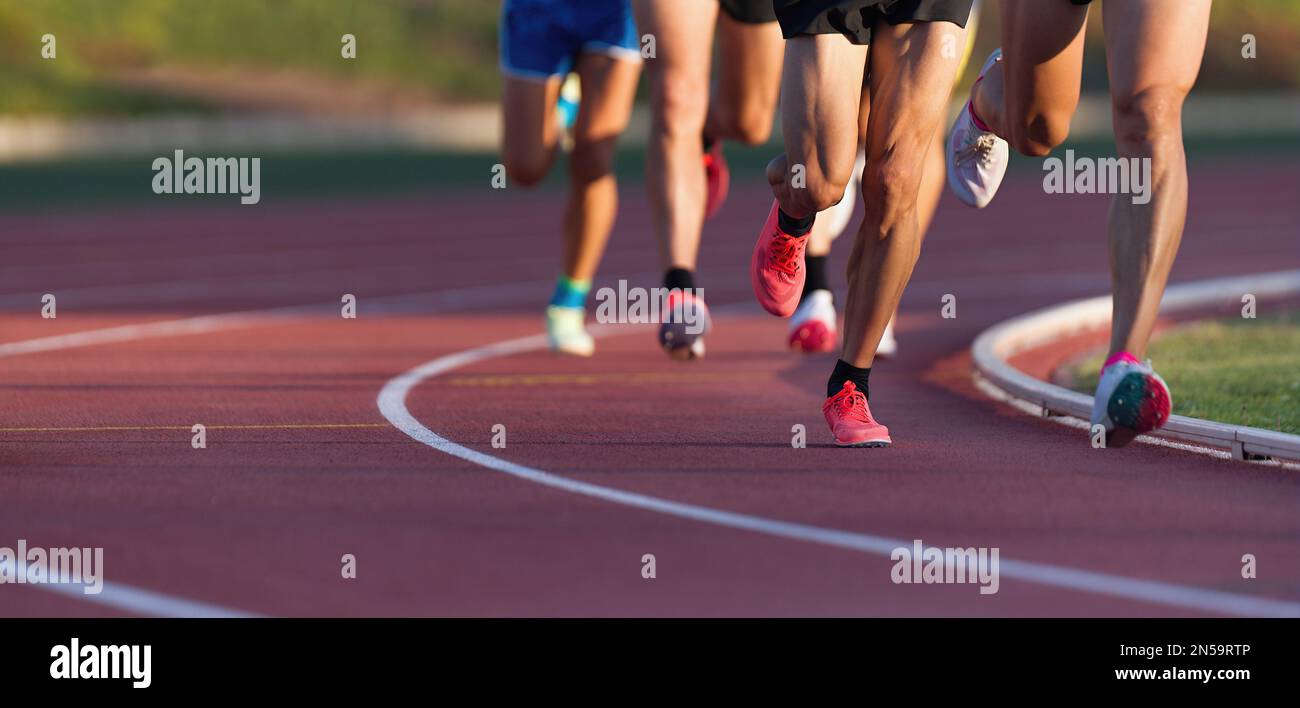 Athletics people running on the track field.Running a race on a track ...